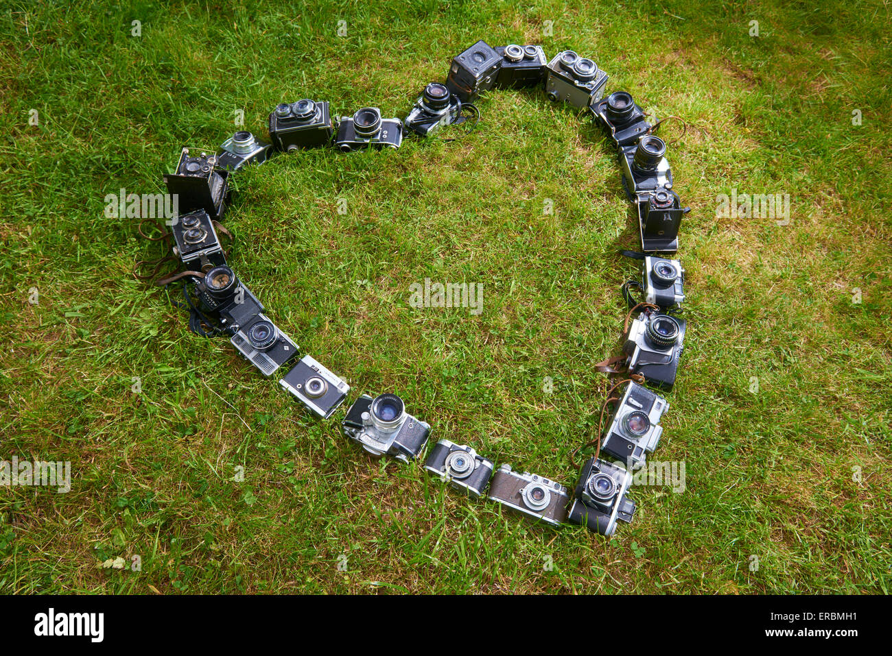 Heart shape made by collection of old vintage retro film cameras, lying ...