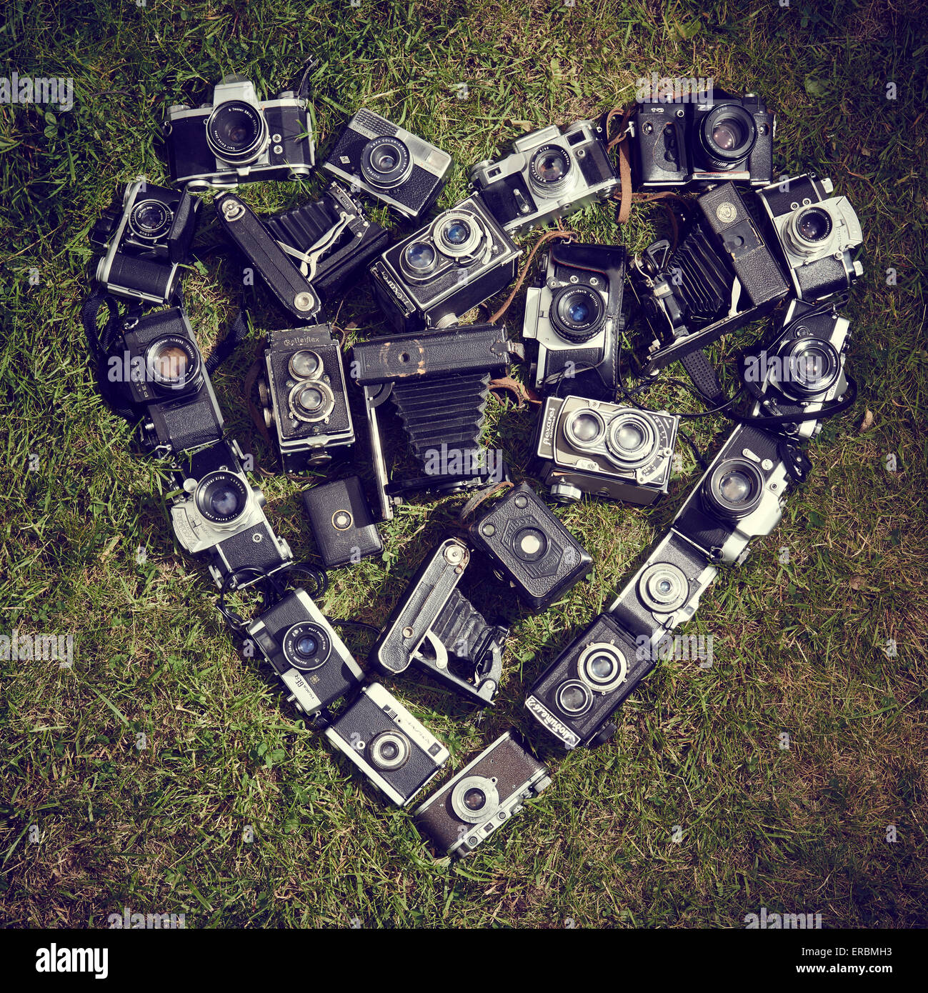 Heart shape made by collection of old vintage retro film cameras, lying ...
