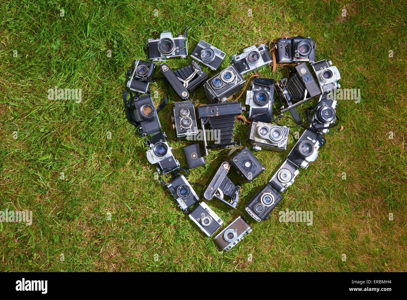 Heart shape made by collection of old vintage retro film cameras, lying ...