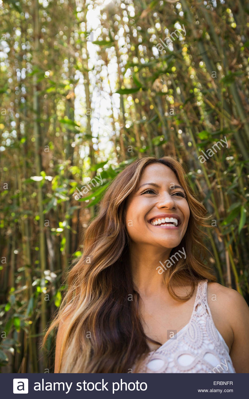 Smiling woman below bamboo Stock Photo - Alamy