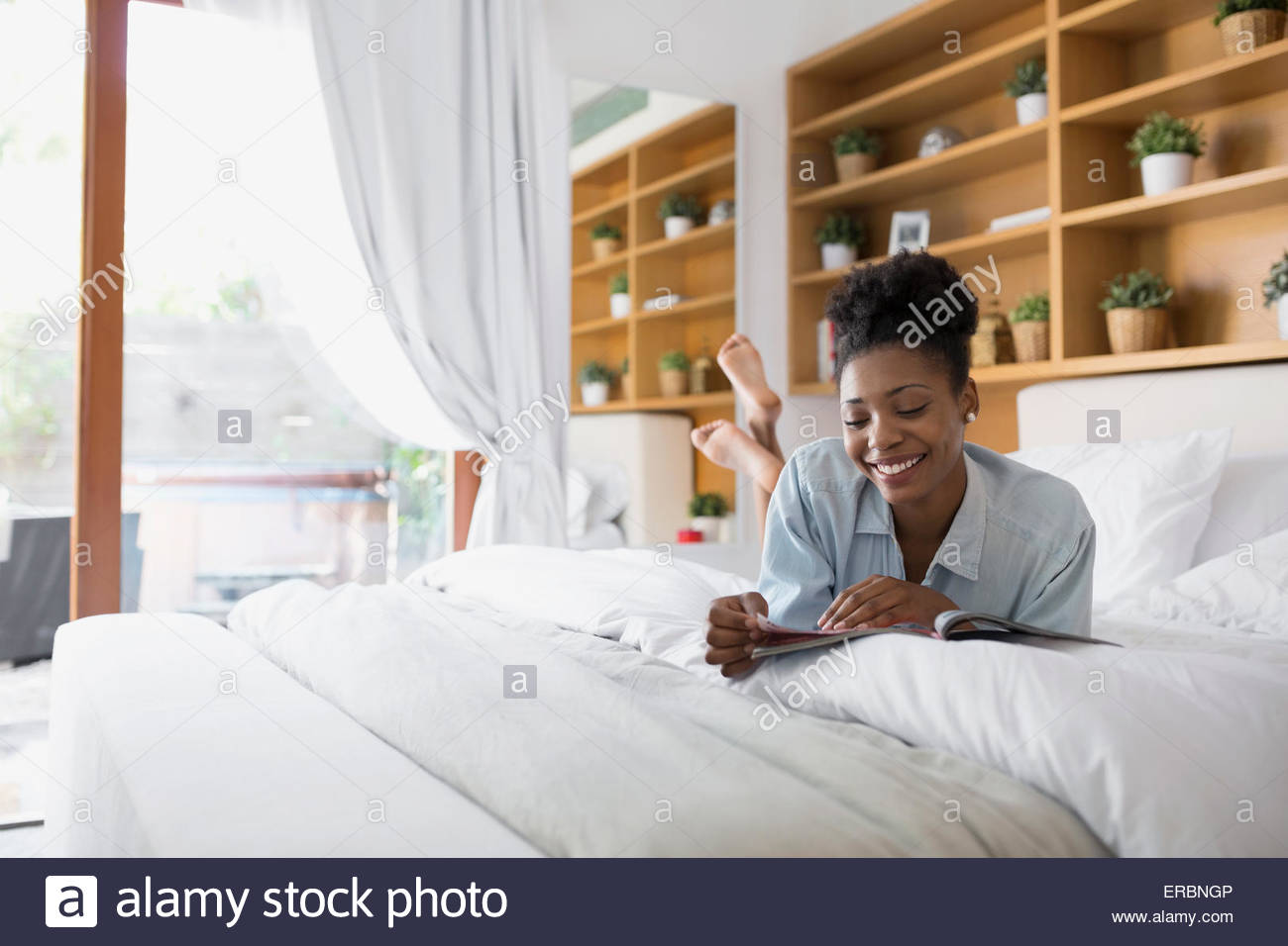 Woman reading magazine bed hi-res stock photography and images - Alamy