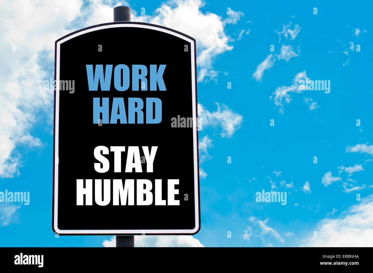 WORK HARD STAY HUMBLE motivational quote written on road sign isolated ...