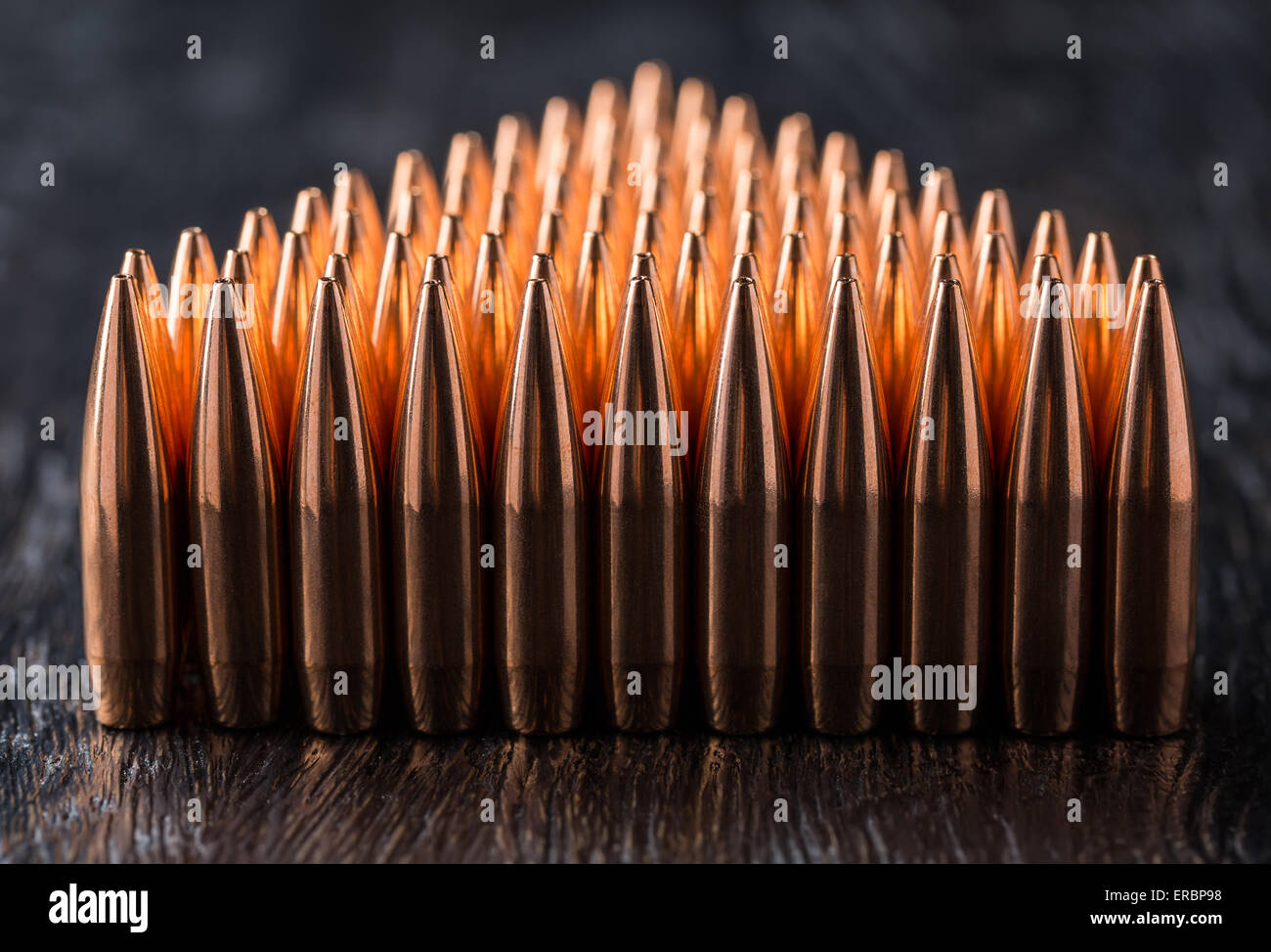 Macro shot of copper bullets that are in many rows to form a tri Stock ...