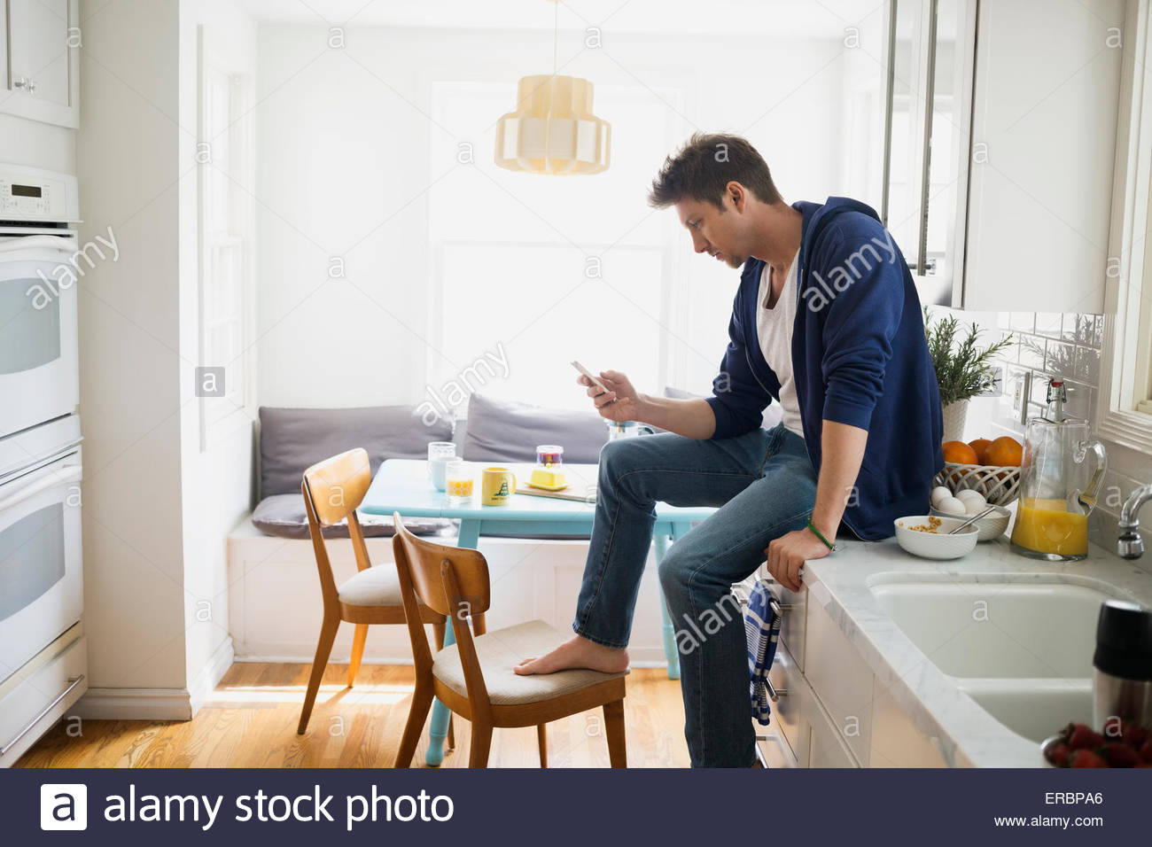 Man sitting at kitchen counter hi-res stock photography and images - Alamy