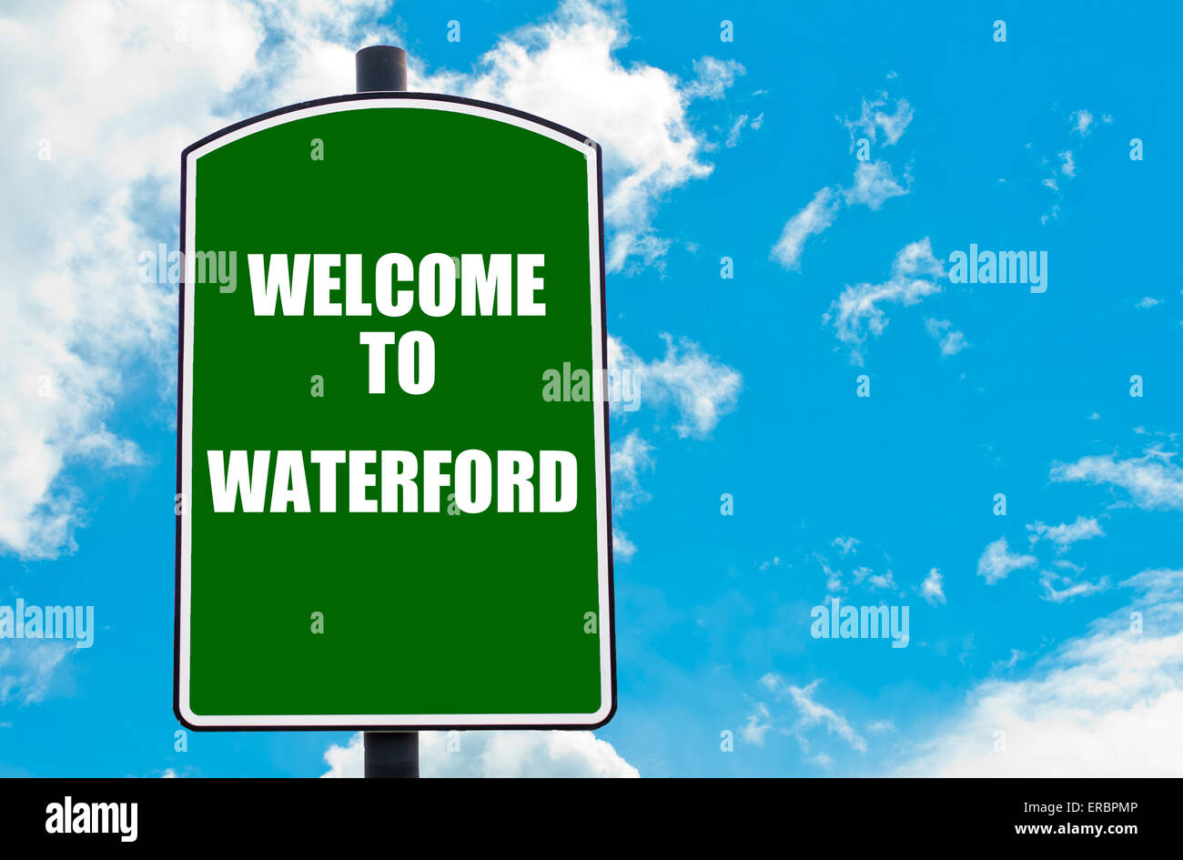 Green road sign with greeting message WELCOME TO WATERFORD isolated ...