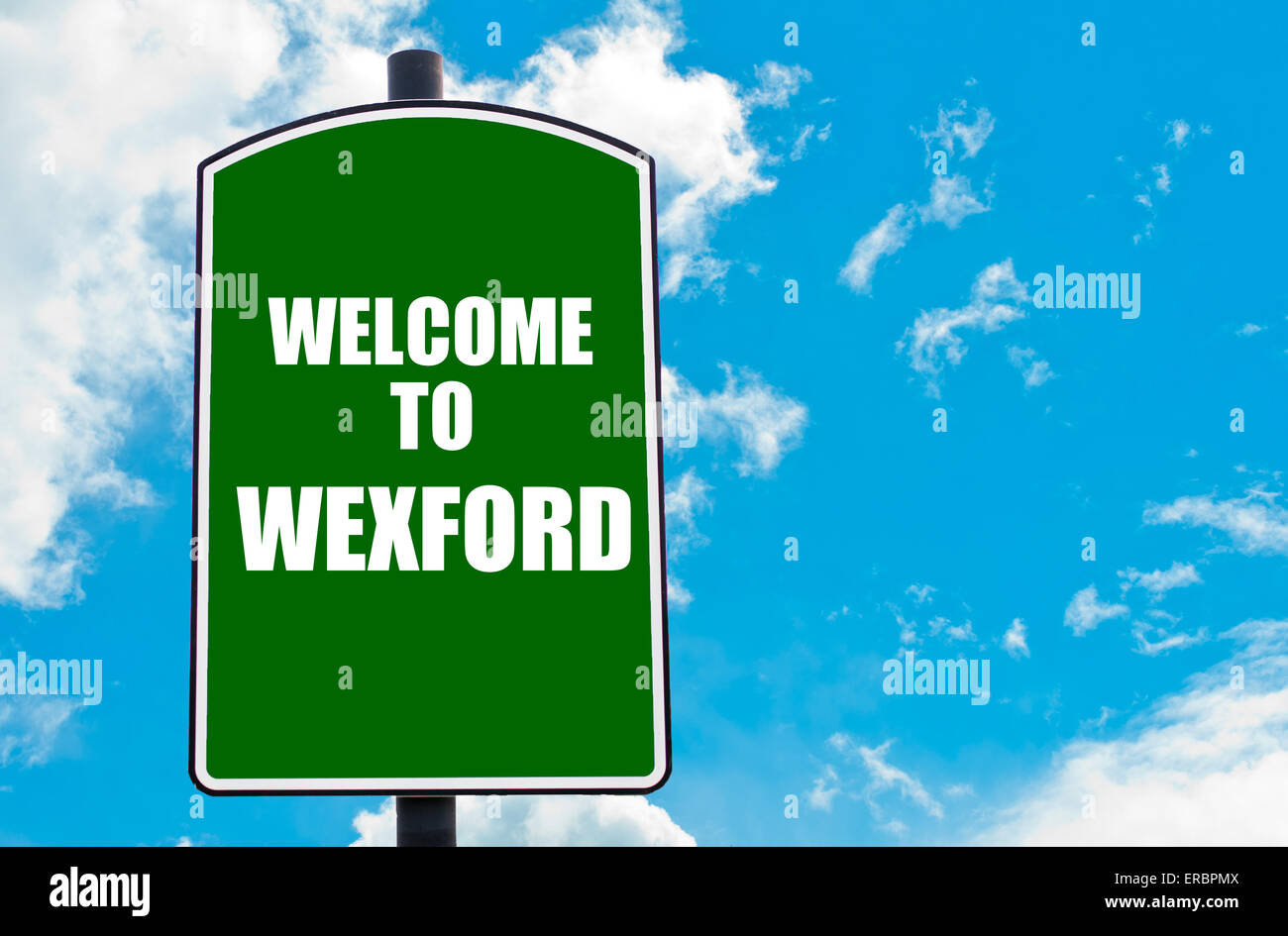 Green road sign with greeting message WELCOME TO WEXFORD isolated over ...