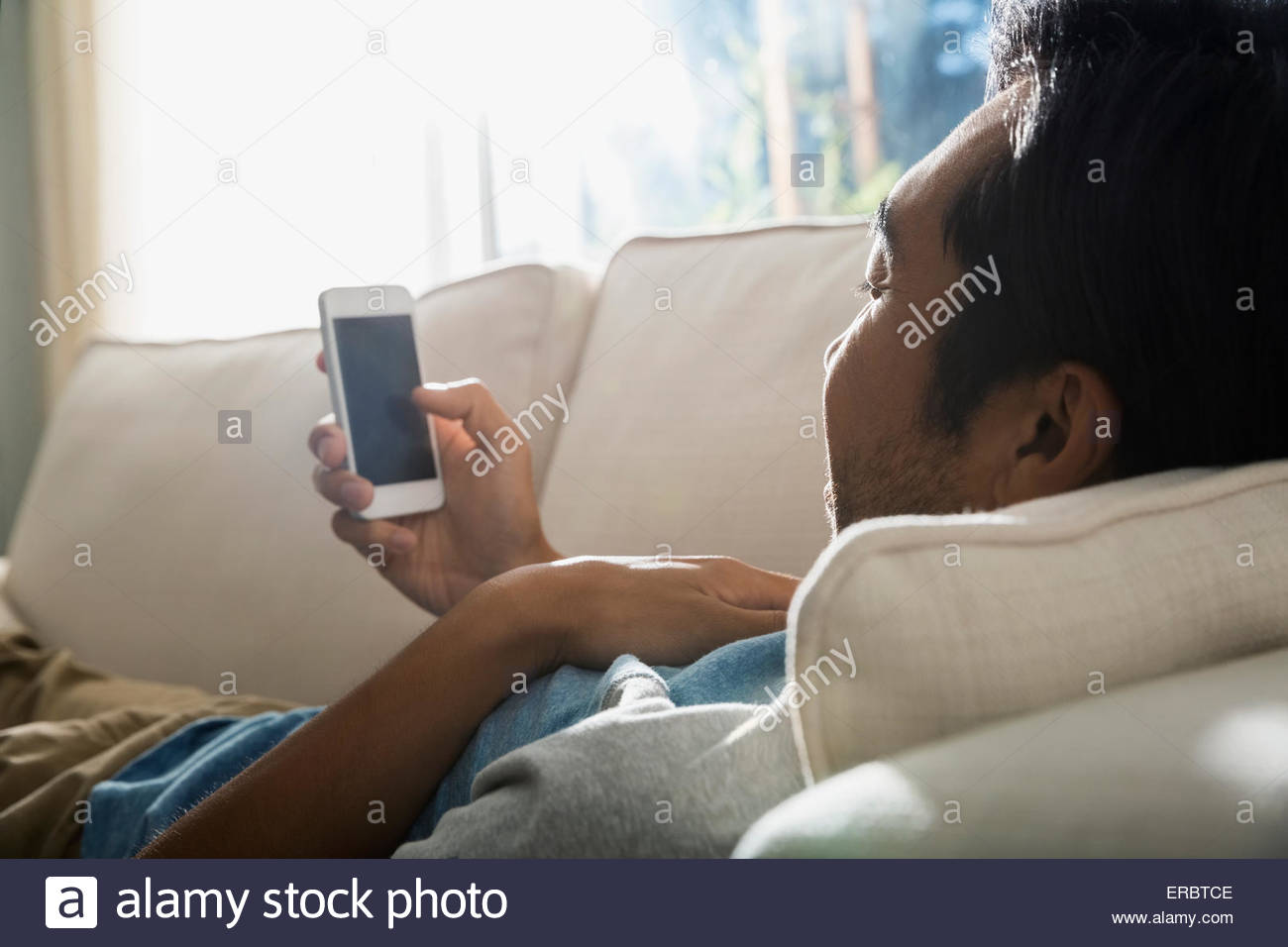 Man laying on sofa hi-res stock photography and images - Alamy