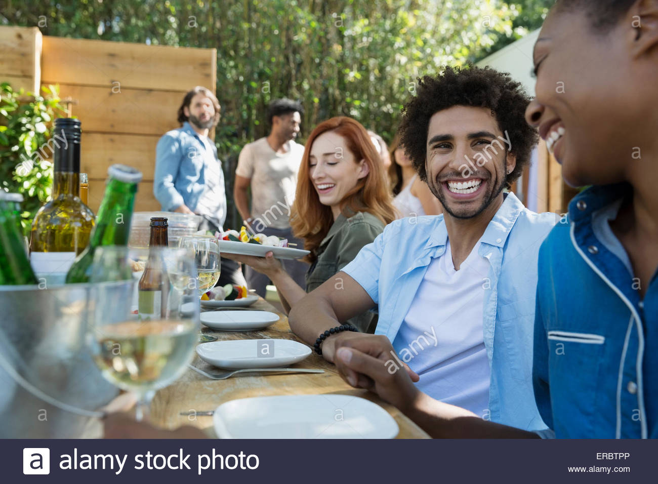 Laughing group of friends table hi-res stock photography and images - Alamy