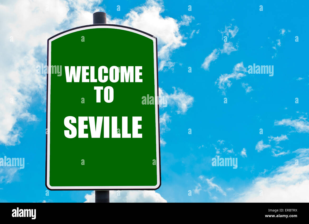 Green road sign with greeting message WELCOME TO SEVILLE isolated over ...