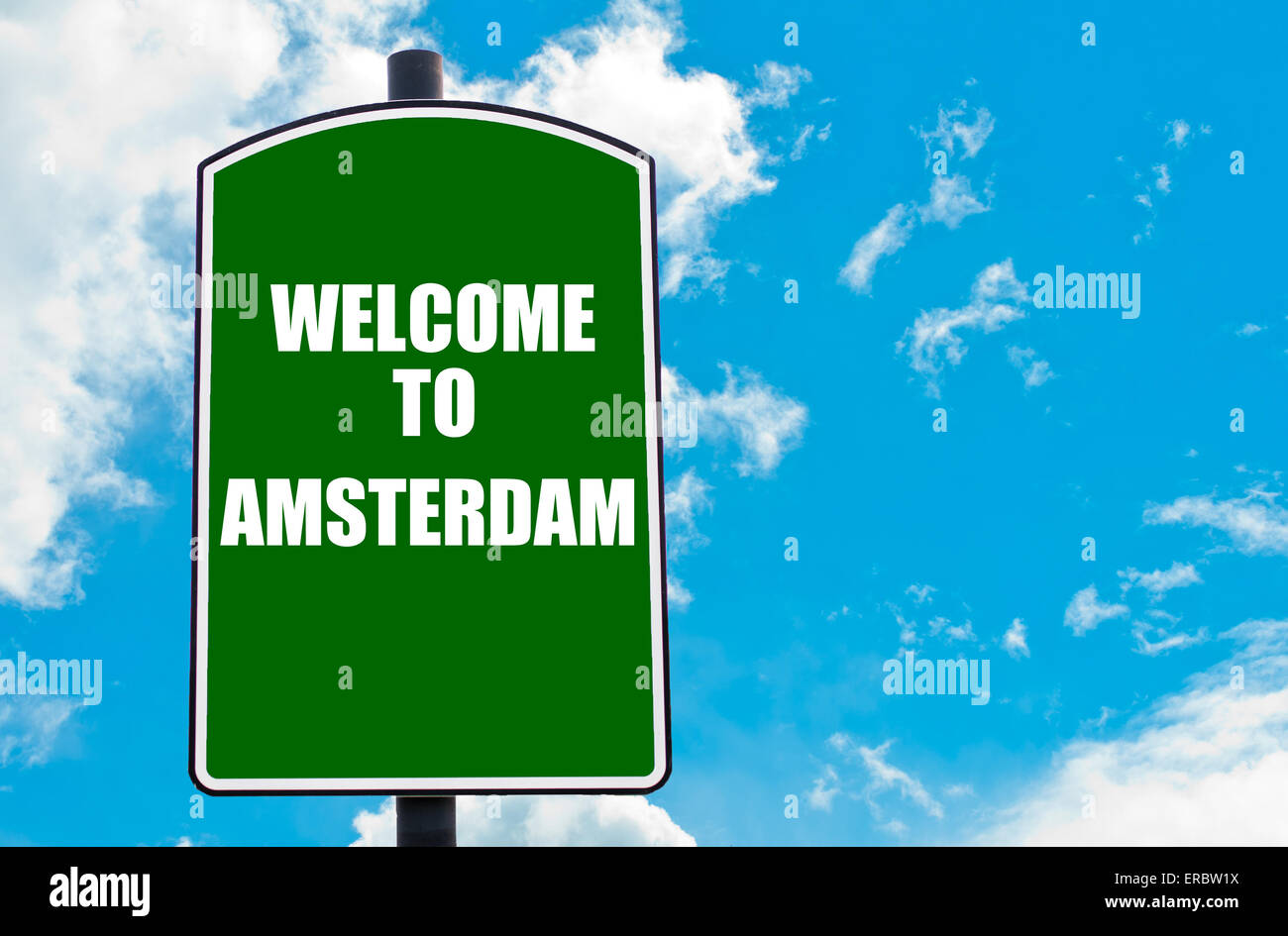 Green road sign with greeting message WELCOME TO AMSTERDAM, NETHERLANDS ...