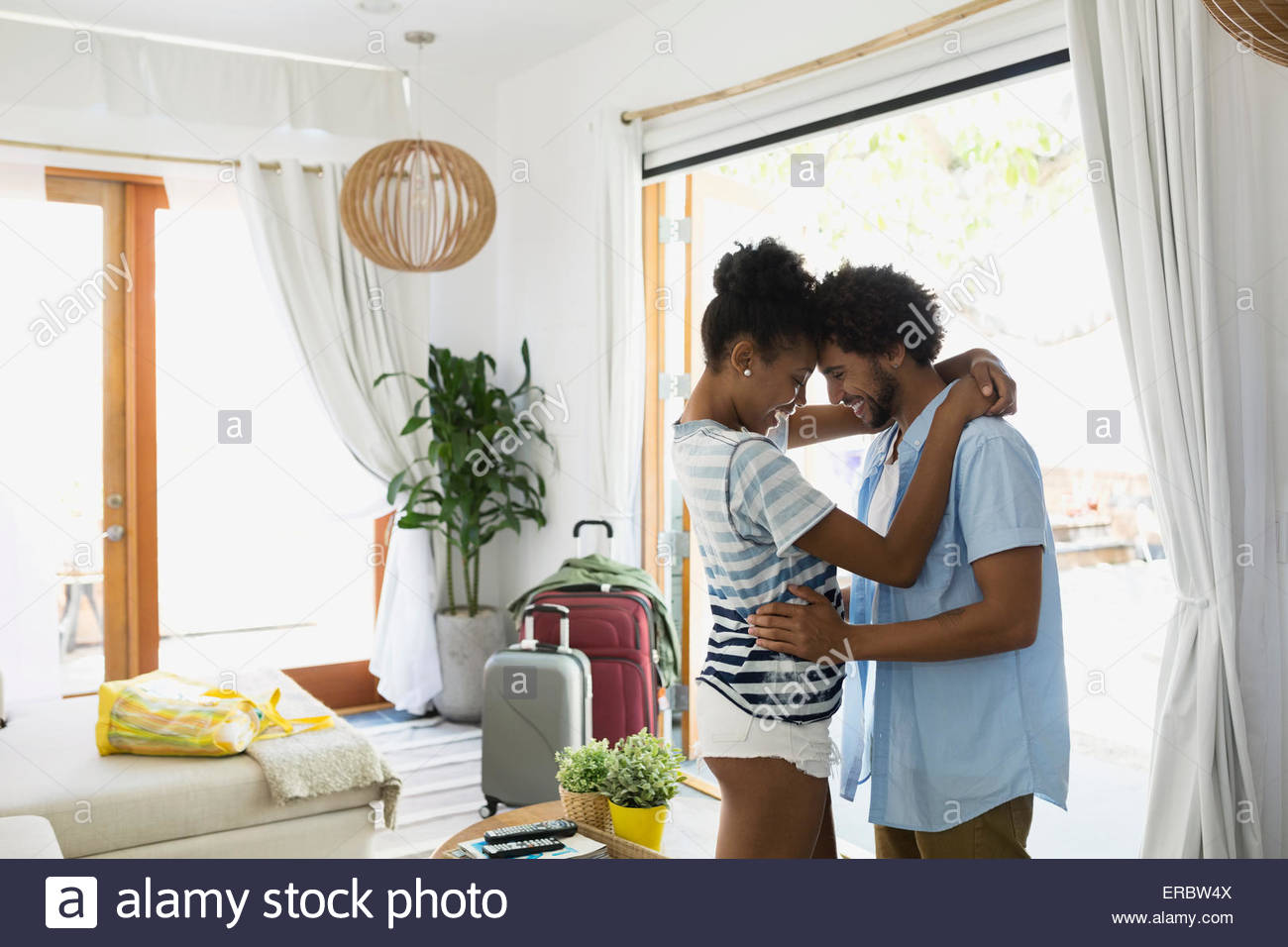 Couple hugging in vacation house living room Stock Photo - Alamy