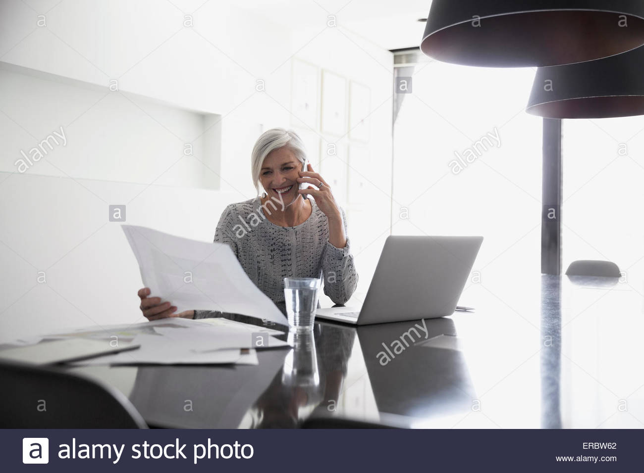 Businesswoman using smart phone reviewing hi-res stock photography and ...