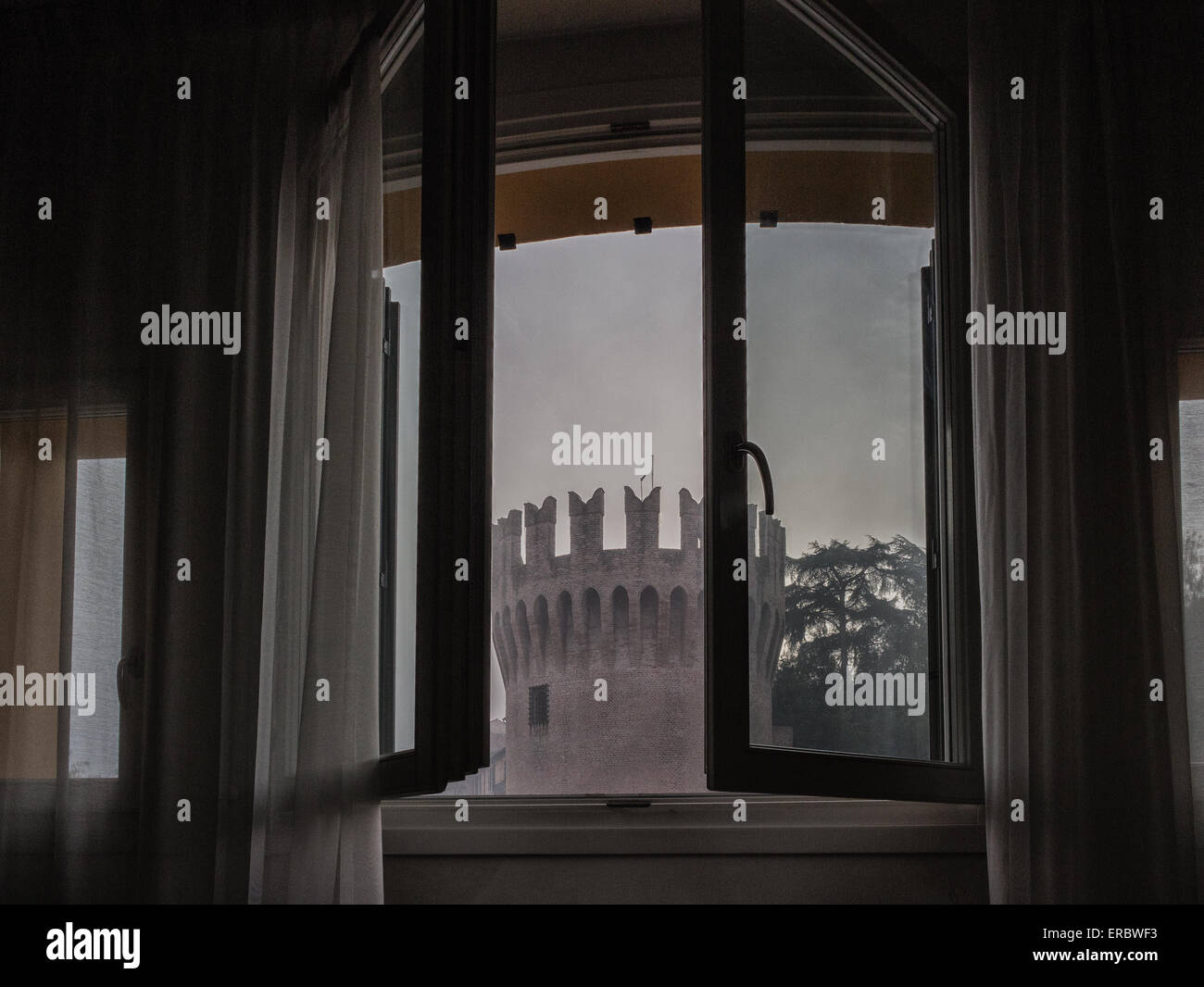 window overlooking medieval tower in the fog in Lugo near Ravenna in ...