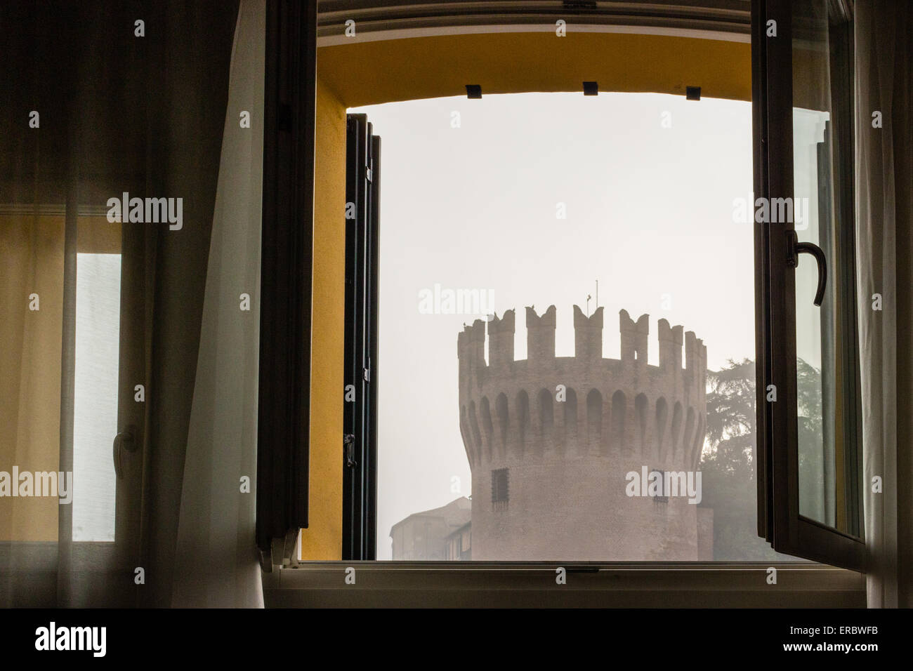 window overlooking medieval tower in the fog in Lugo near Ravenna in ...