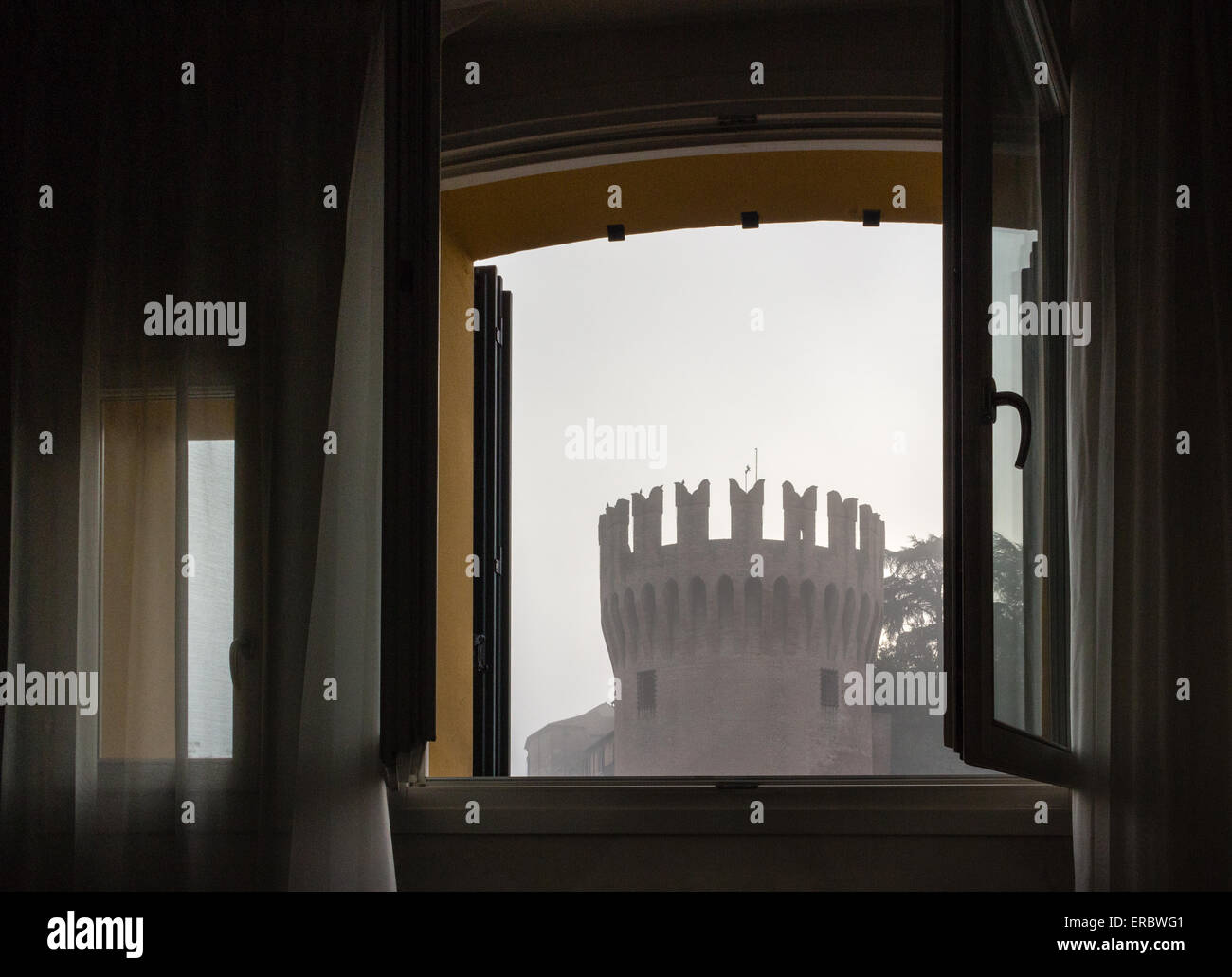 window overlooking medieval tower in the fog in Lugo near Ravenna in ...