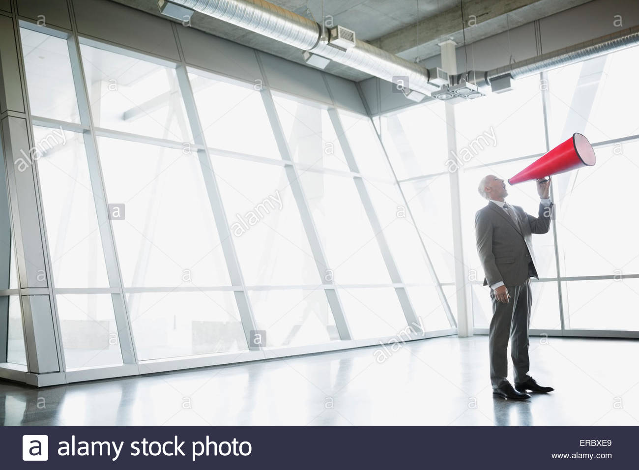 Businessman shouting into megaphone Stock Photo - Alamy