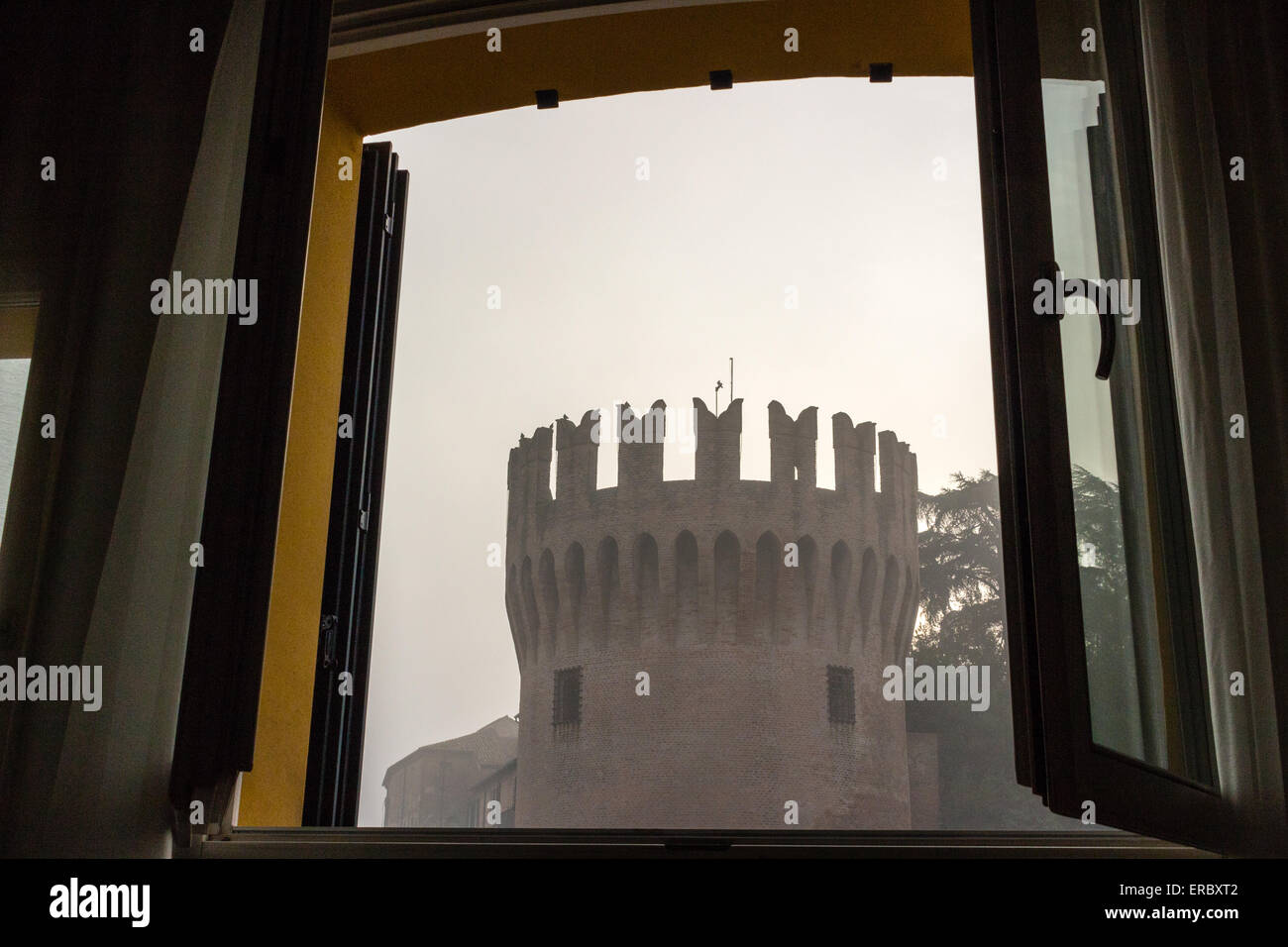 window overlooking medieval tower in the fog in Lugo near Ravenna in ...