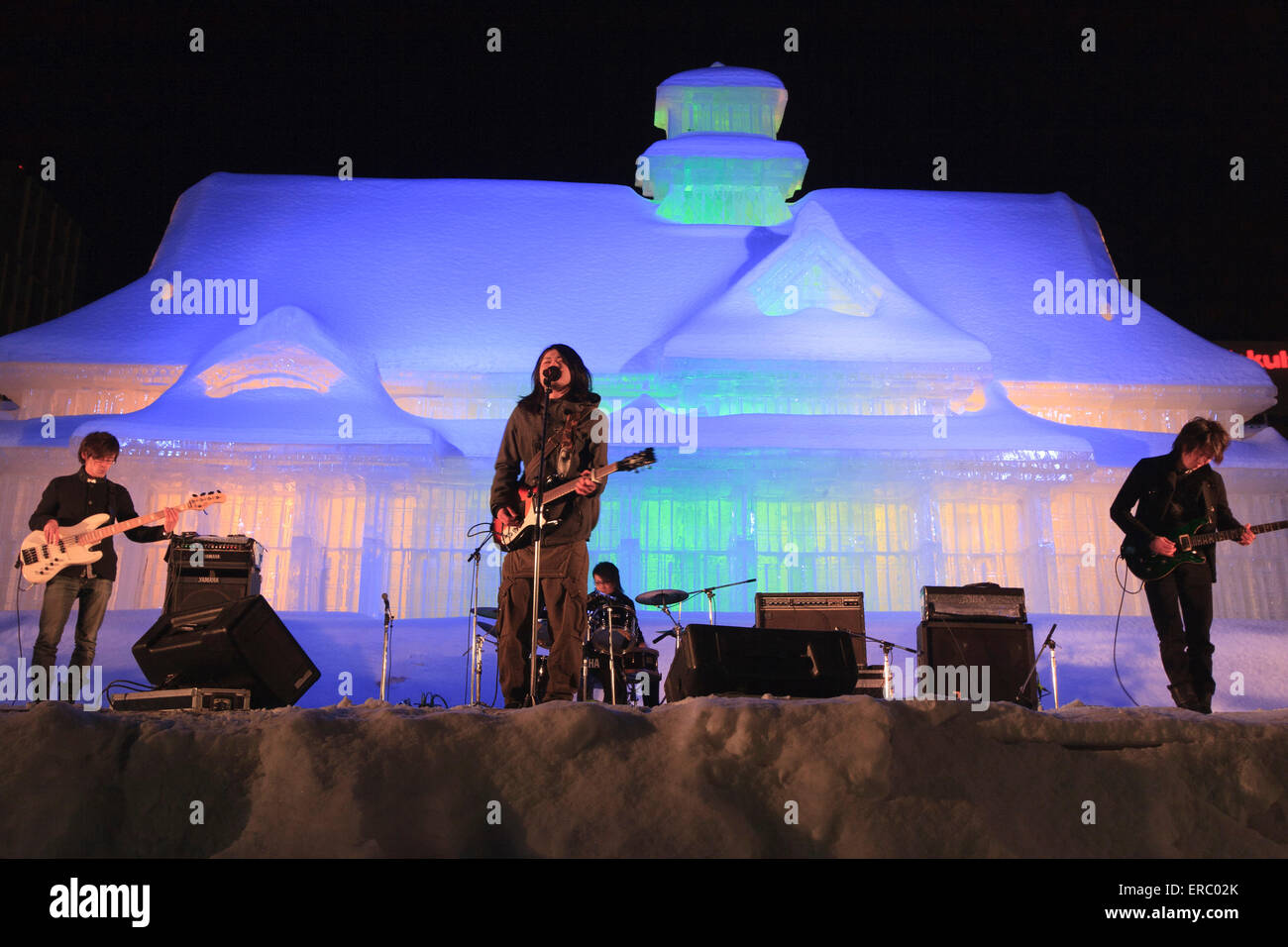 A Japanese rock band performs at the foot of a giant illuminated snow ...
