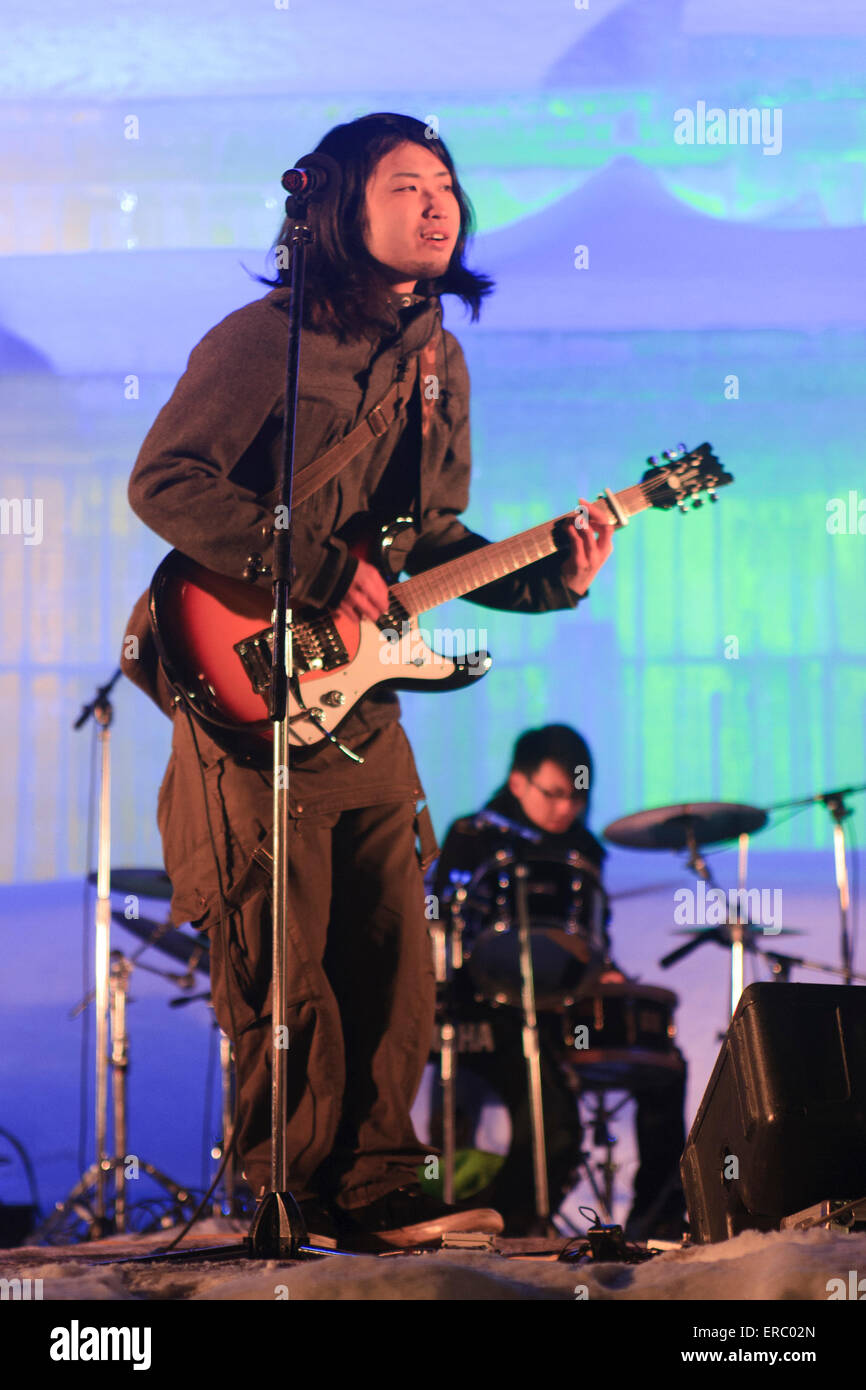 A Japanese rock band performs at the foot of a giant illuminated snow ...