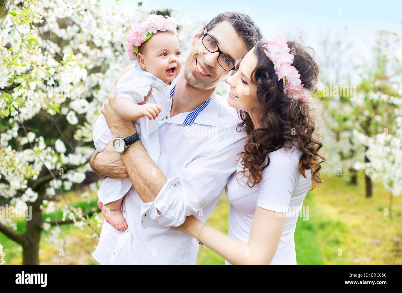 Proud parents hugging their little baby Stock Photo - Alamy
