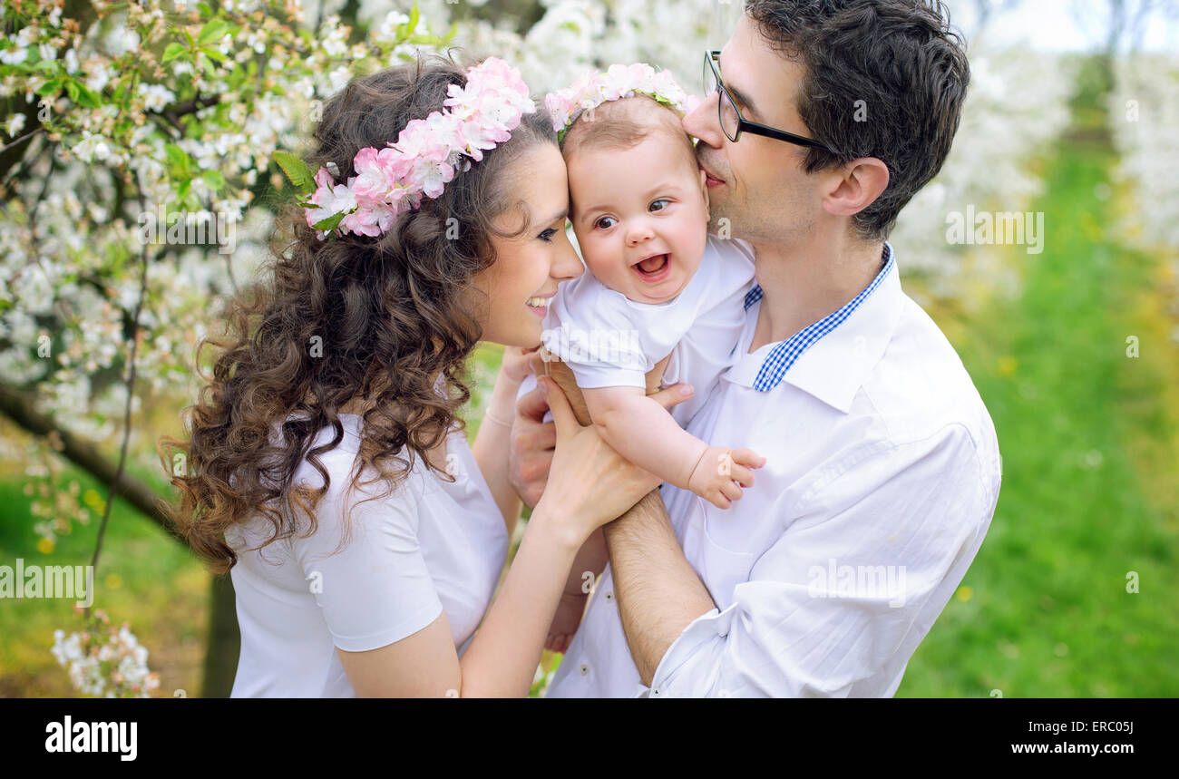 Cheerful parents kissing their beloved baby Stock Photo - Alamy