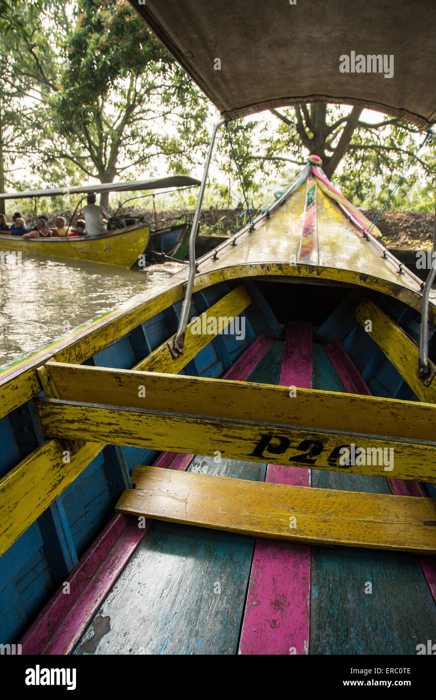 The front of a long-tailed speed boat as it moves through a river to ...