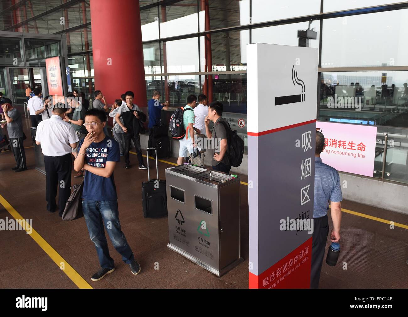 Beijing, China. 1st June, 2015. People smoke at a smoking area outside ...