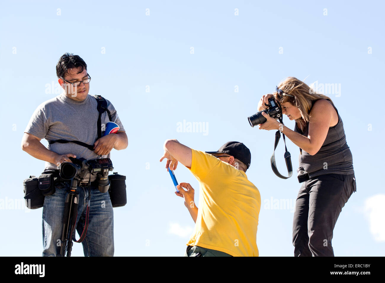Three photographers together with one modeling Stock Photo - Alamy