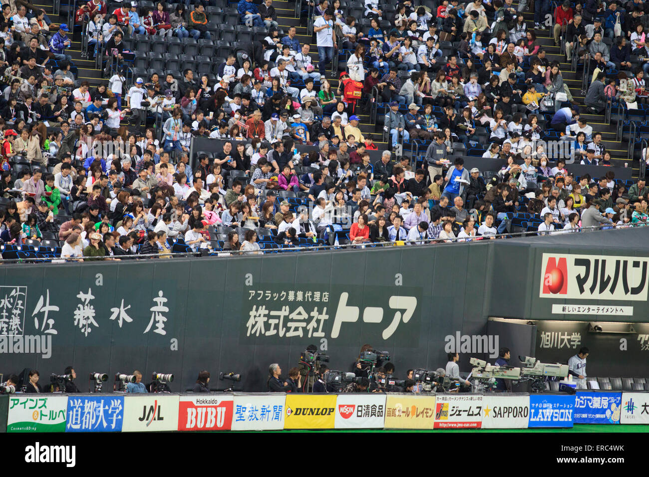 A giant crowd of people at the Sapporo Dome in Sapporo, Hokkaido gather ...