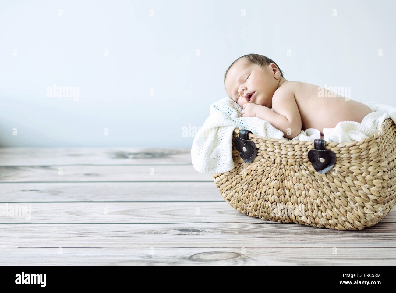 Cute toddler having a nap in a wicker basket Stock Photo - Alamy