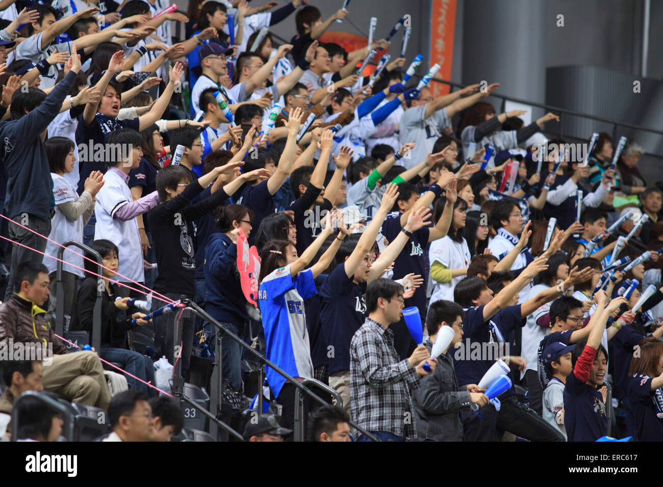 A giant crowd of people at the Sapporo Dome in Sapporo, Hokkaido gather ...