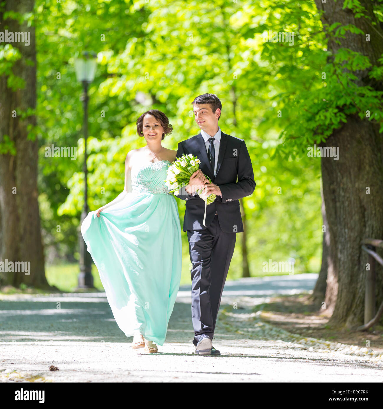 Happy wedding couple walking path hi-res stock photography and images ...