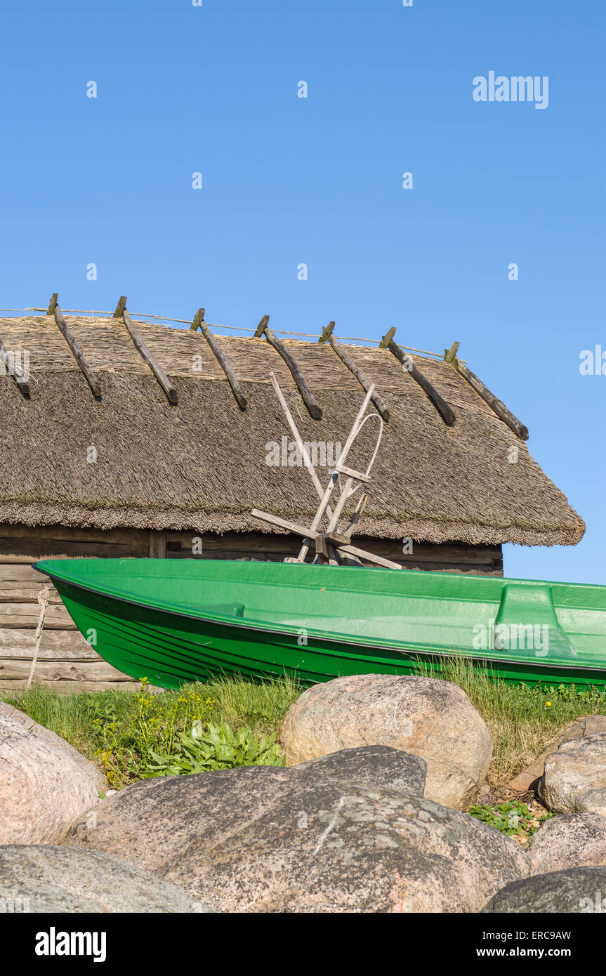 Fisherman rowboat and old rustic utility house Stock Photo - Alamy