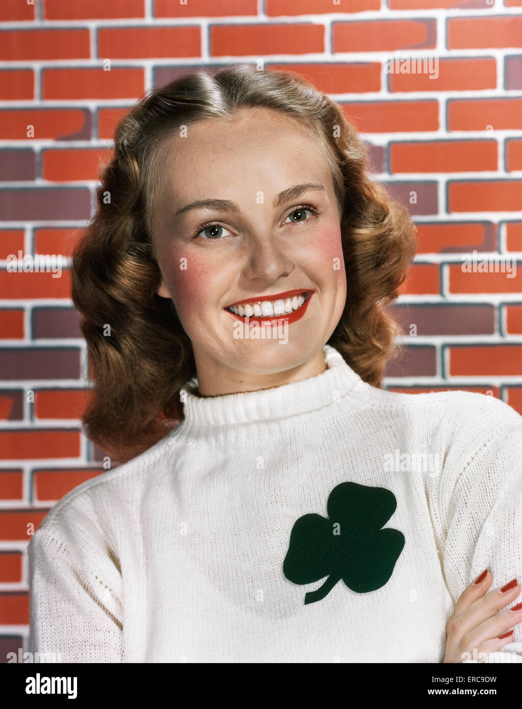 1940s 1950s PORTRAIT SMILING WOMAN WEARING WHITE SWEATER WITH SHAMROCK ...