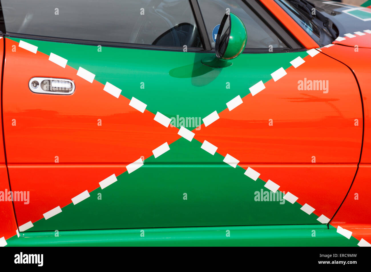 decorative detail on side of colourful orange and green Mazda MX-5 car ...