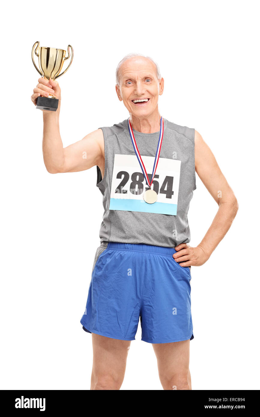 Vertical shot of a joyful mature runner holding a trophy and ...