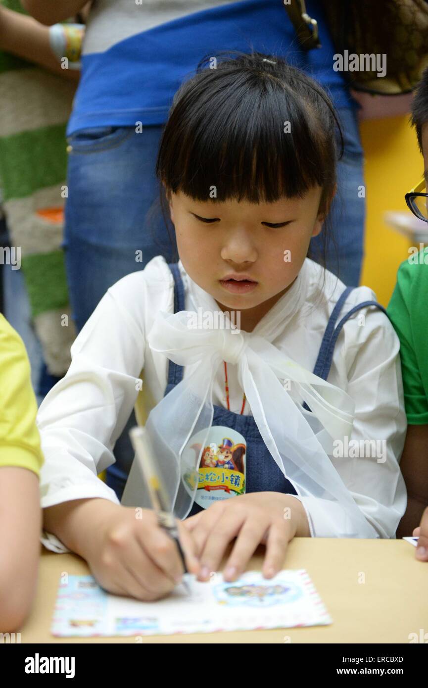 Harbin, China's Heilongjiang Province. 1st June, 2015. A girl writes a ...