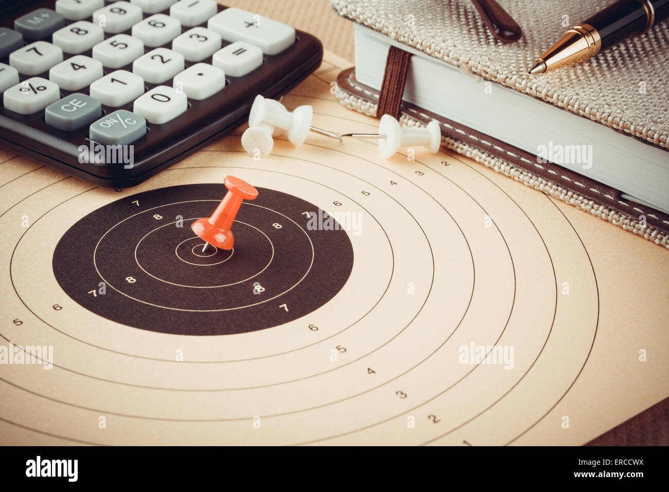 Red pin in target, pocket calculator, objectives and planning concept ...