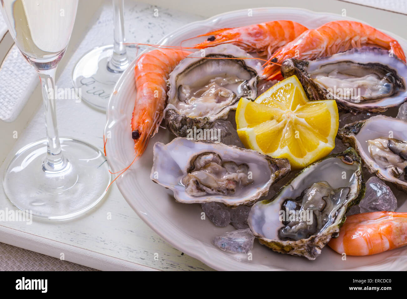 Garnished oysters shell, jumbo shrimp with lemon on ice, top view Stock ...