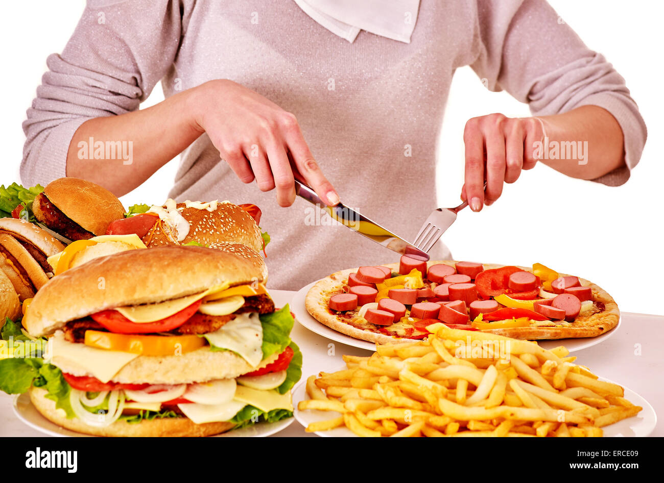 Woman eating junk food Stock Photo - Alamy