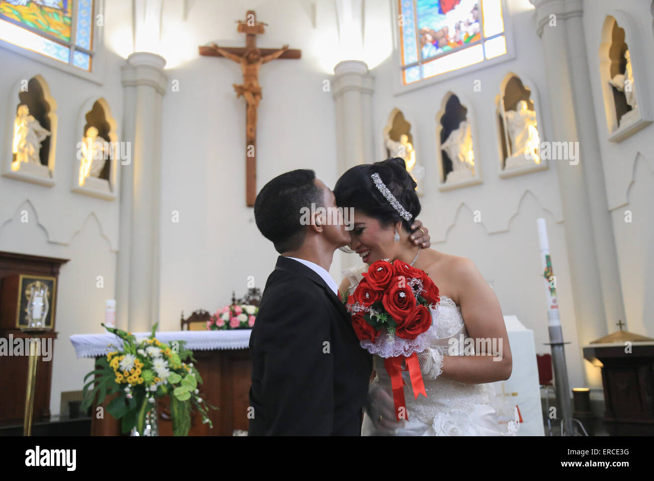 Kissing the bride at the alter in church after wedding ceremony Stock ...