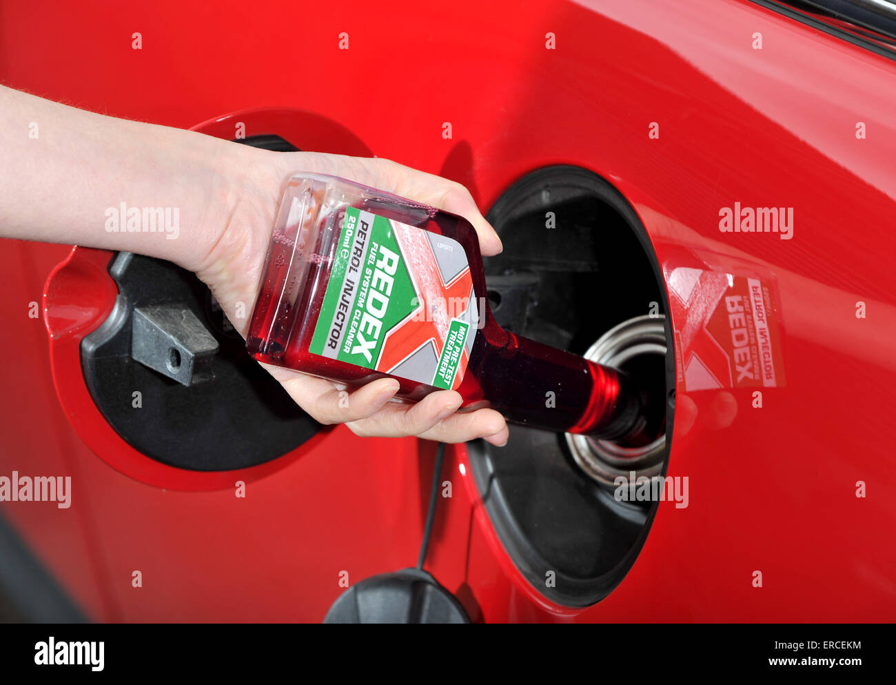 pouring fuel system cleaner into the tank of a car Stock Photo - Alamy