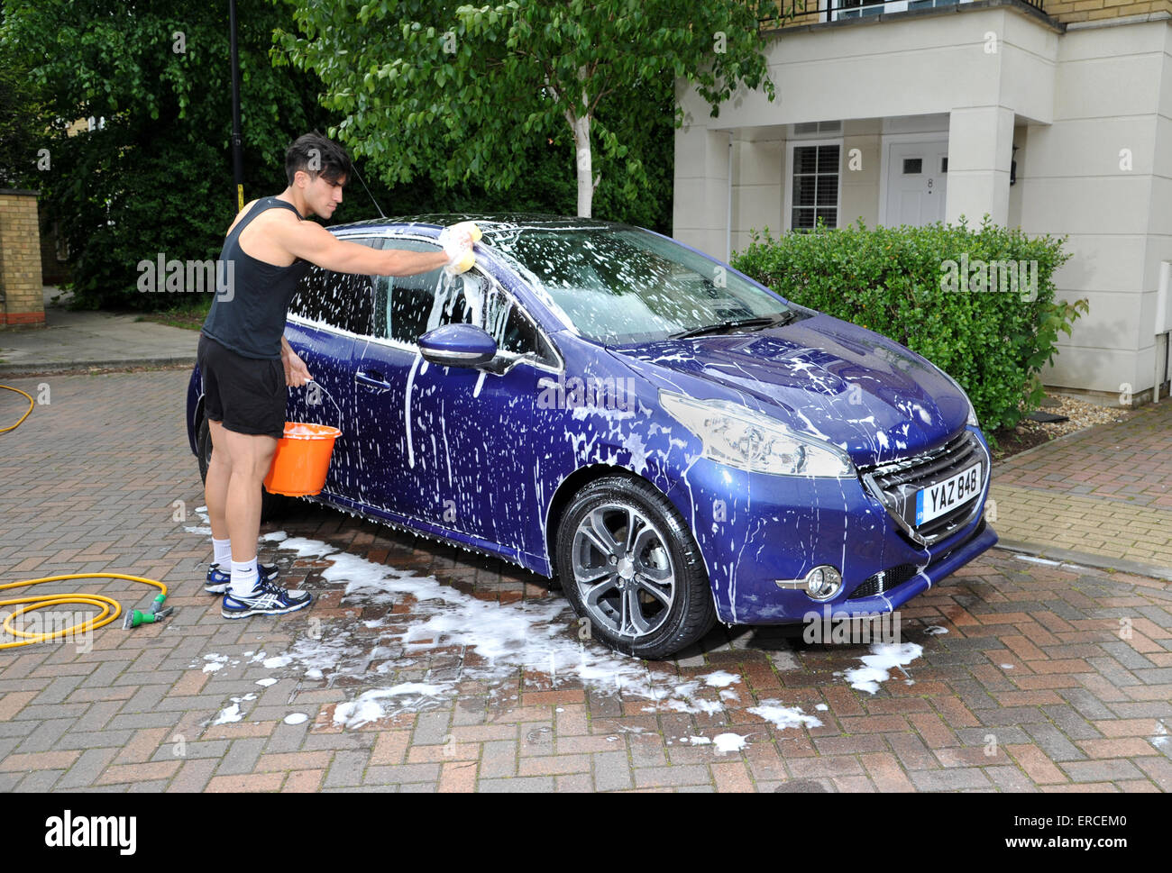 Young man washing a car Stock Photo - Alamy