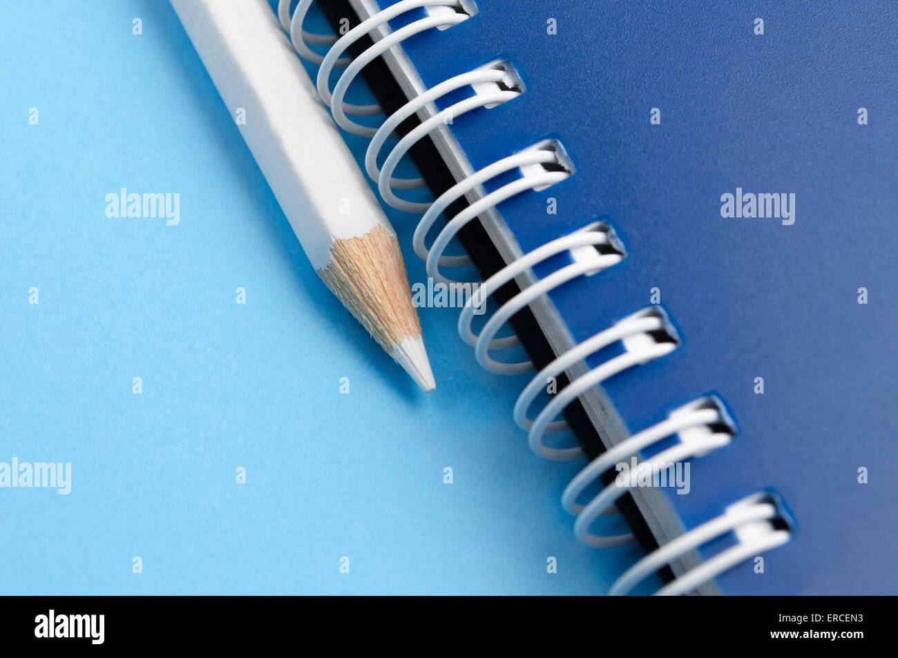 White pencil and spiral of notebook - macro Stock Photo - Alamy