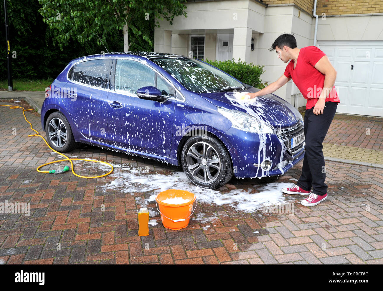 Young man washing a car Stock Photo - Alamy