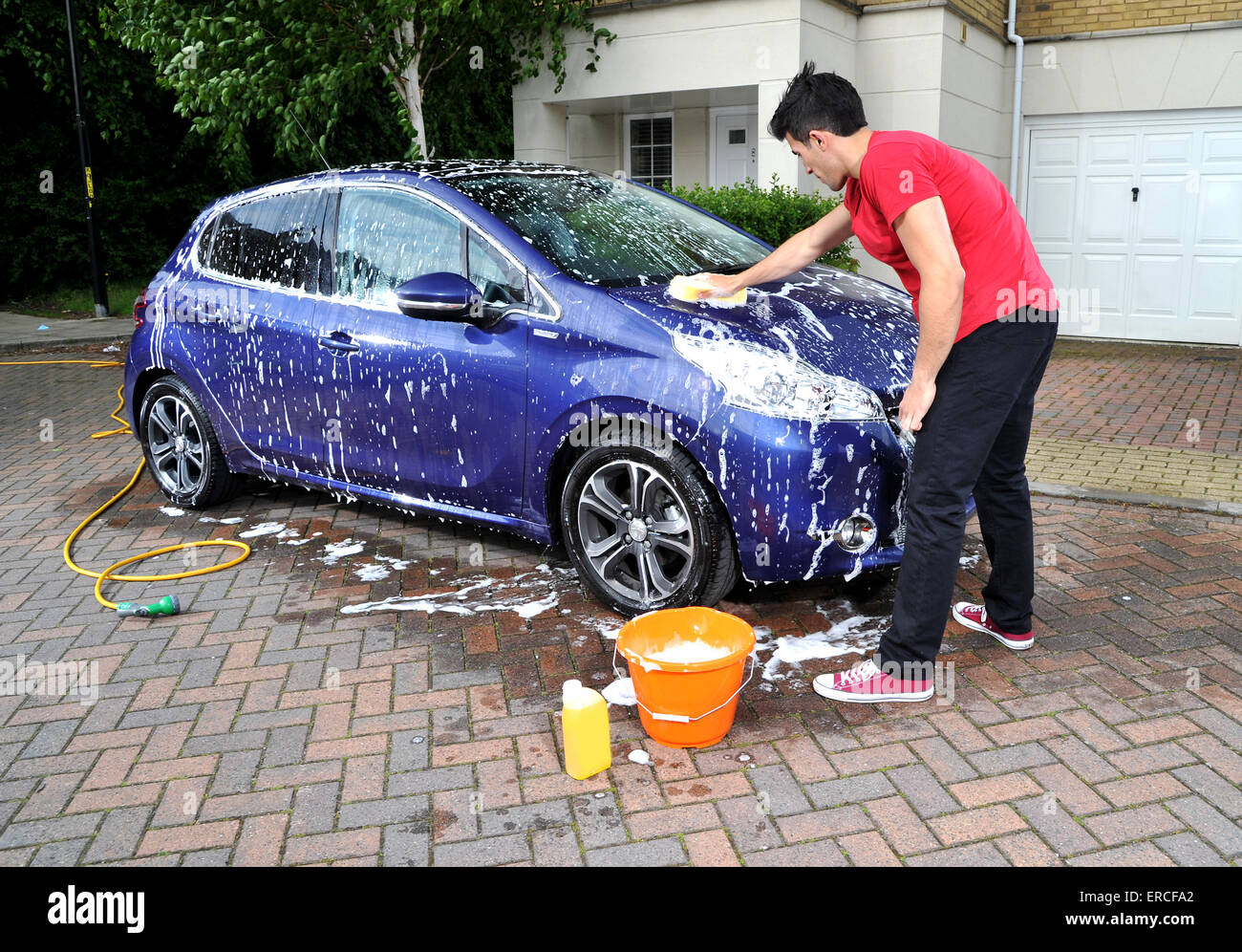 Young man washing a car Stock Photo - Alamy