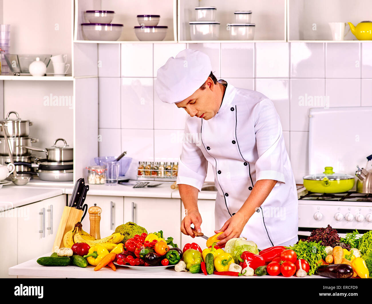 Man in chef hat cooking Stock Photo - Alamy