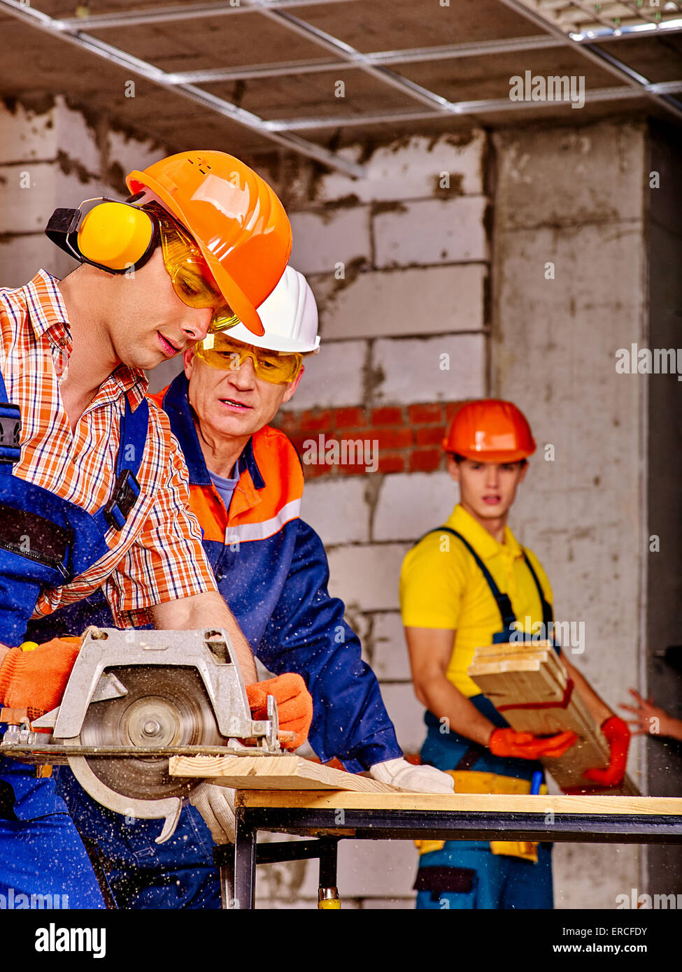 Group people builder with circular saw Stock Photo - Alamy