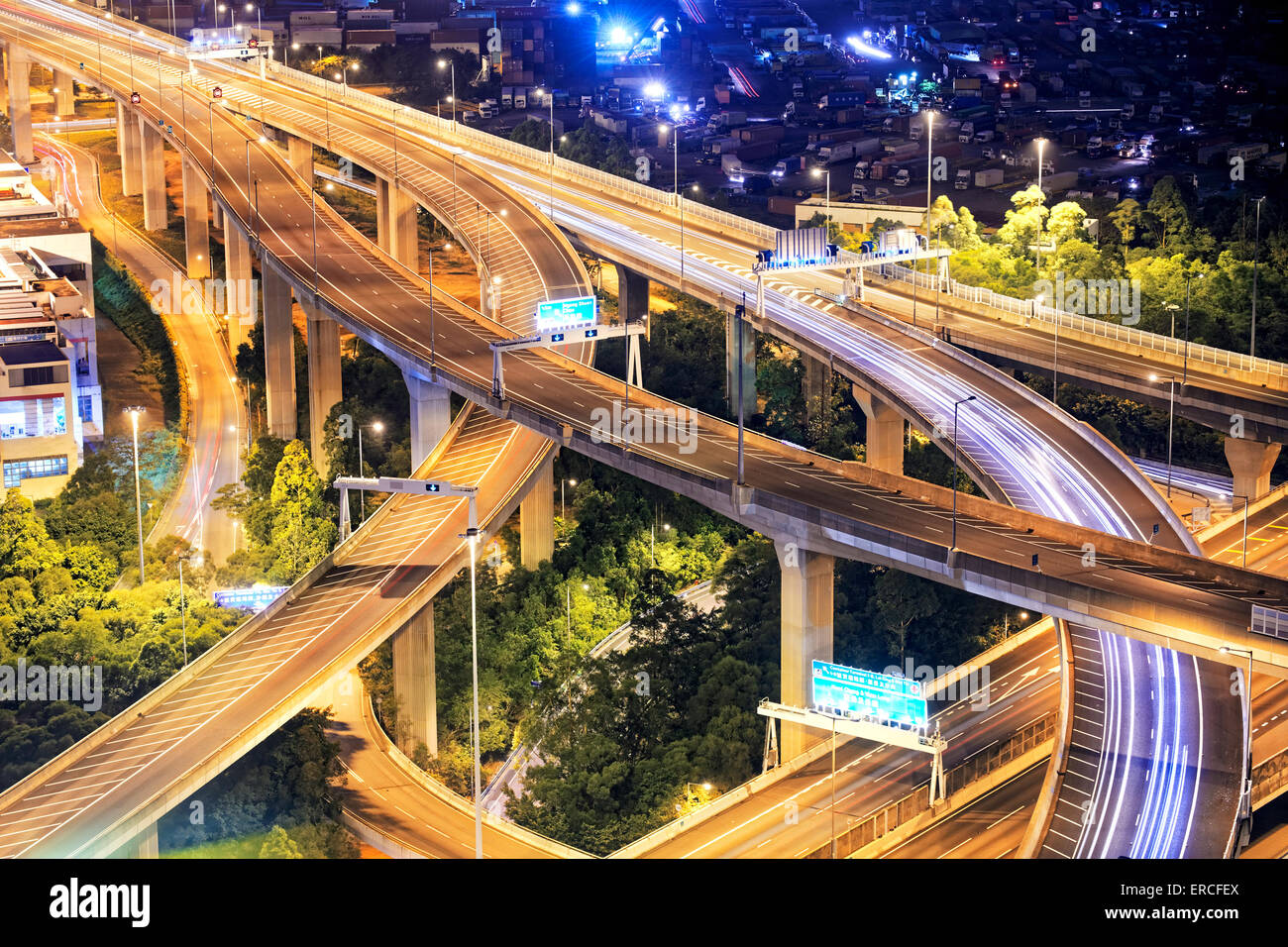 Highway traffic, light trails on the modern building background in Hong ...