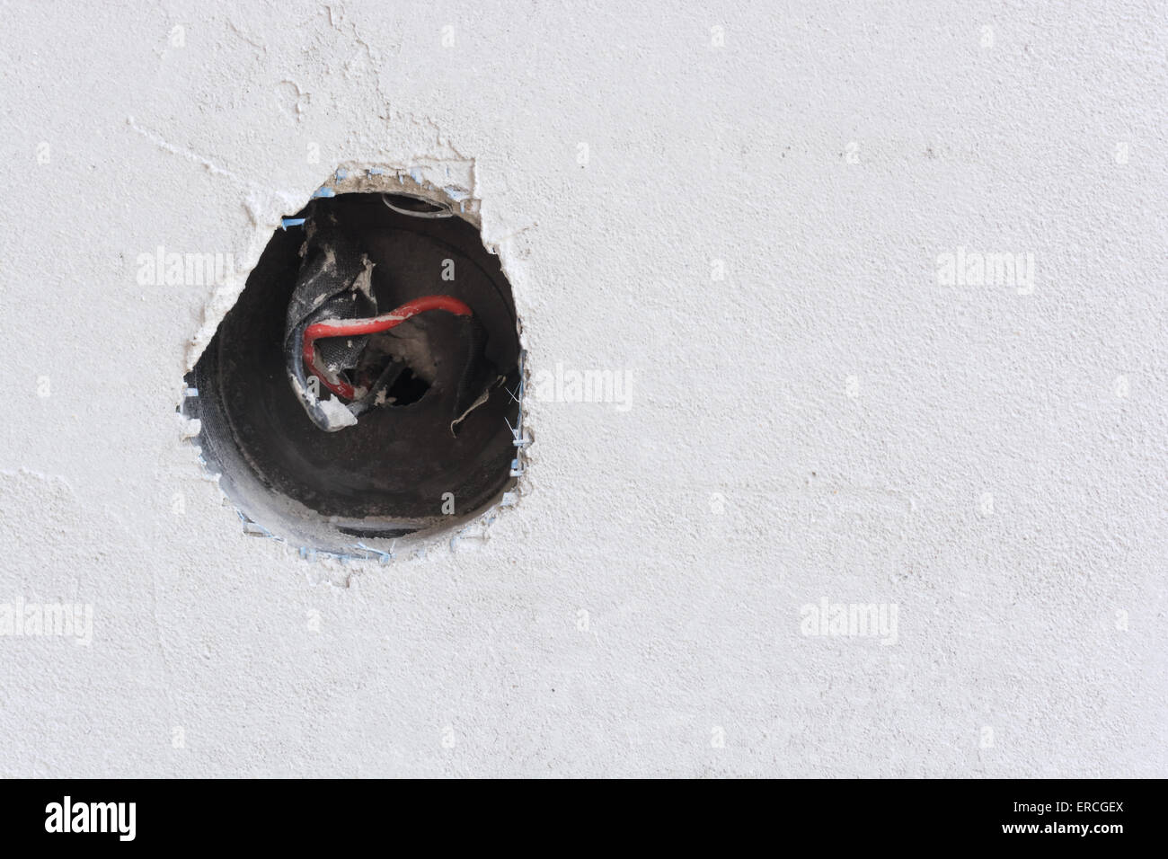 Plastered wall with exposed wires in wall socket Stock Photo - Alamy